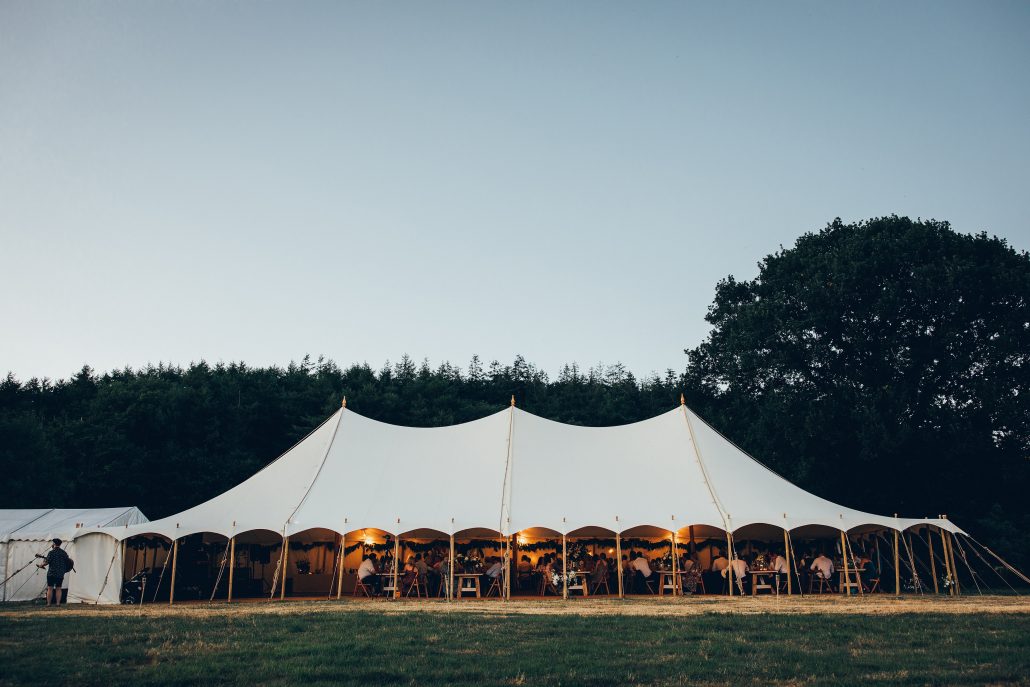 Stunning Petal Pole marquee at dusk • The Marquee Hire Company